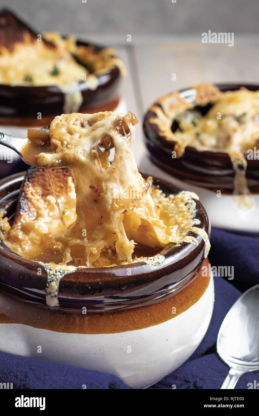 French Onion Soup with Cheese Pull Stock Photo - Alamy