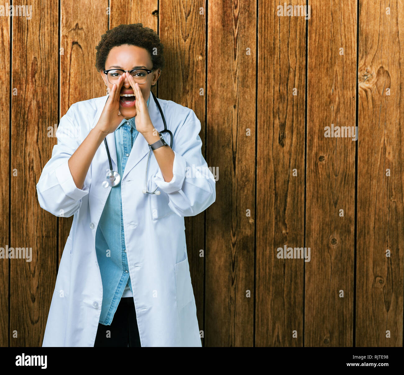 Young african american doctor woman wearing medical coat over isolated ...