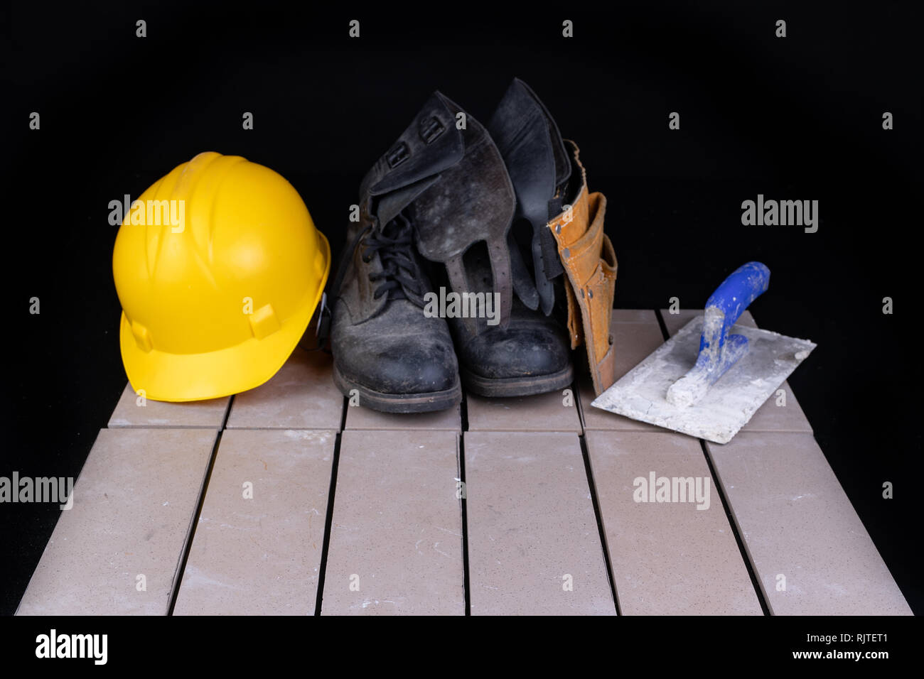 Helmet, protective clothing and trowel for applying mortar. Masonry ...