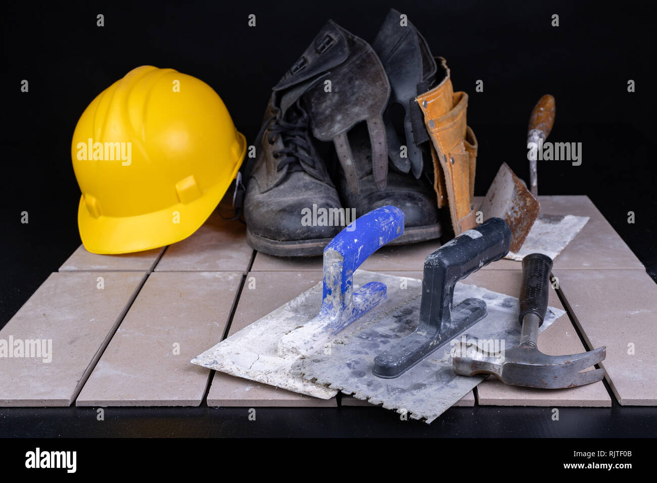Helmet, protective clothing and trowel for applying mortar. Masonry ...