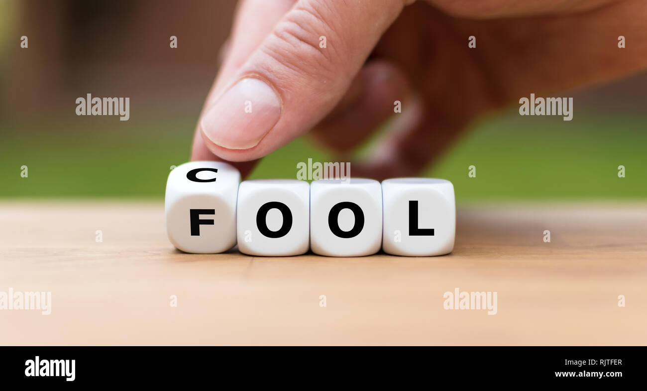 Be cool and not a fool. Hand is turning a dice and changes the word ...