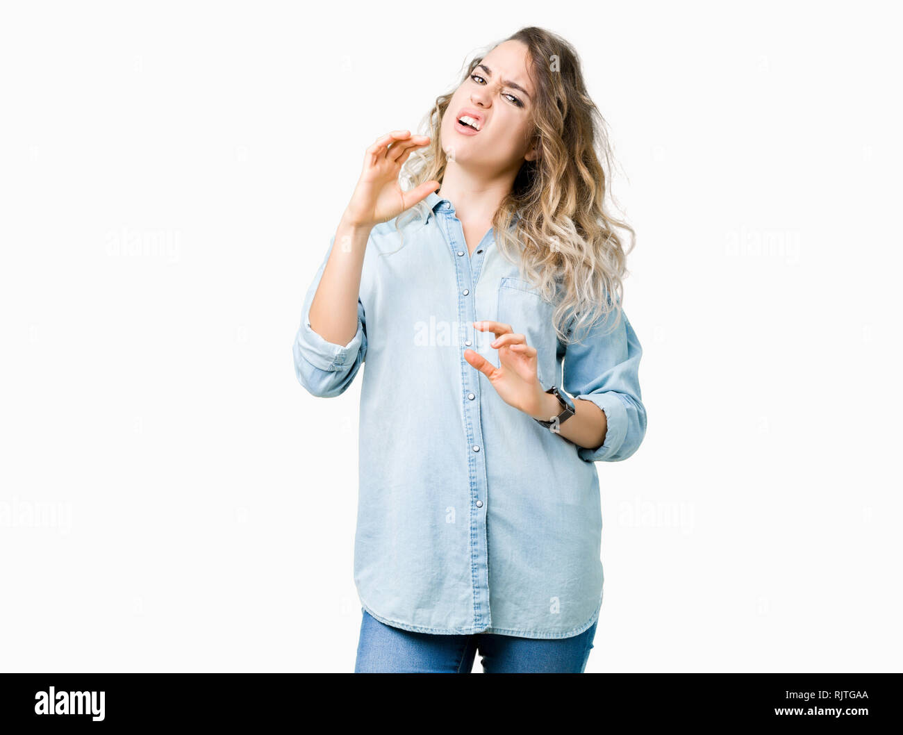 Beautiful young blonde woman over isolated background disgusted ...