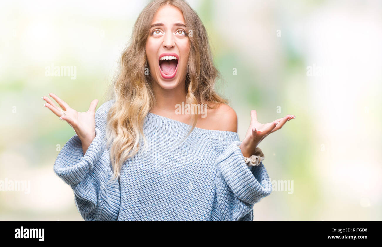 Beautiful young blonde woman wearing winter sweater over isolated ...