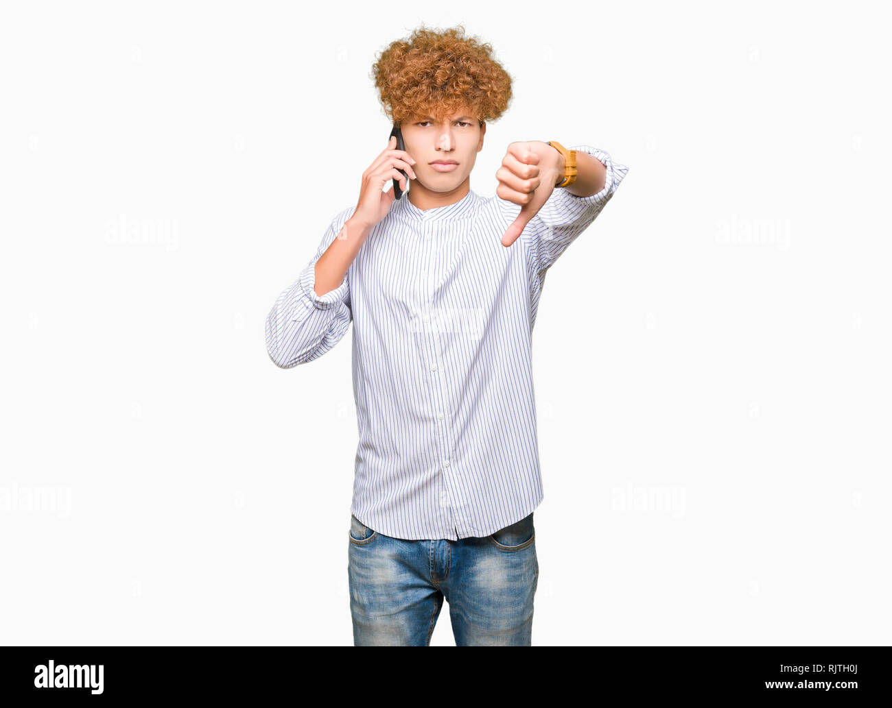 Young handsome man talking on the phone with angry face, negative sign ...
