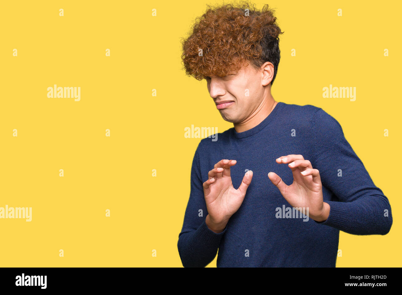 Young handsome man with afro hair disgusted expression, displeased and ...