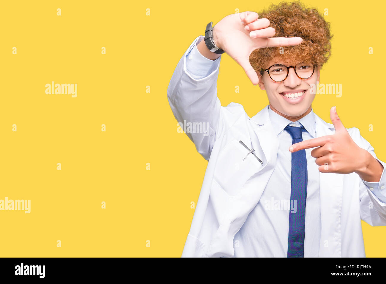 Young handsome scientist man wearing glasses smiling making frame with ...