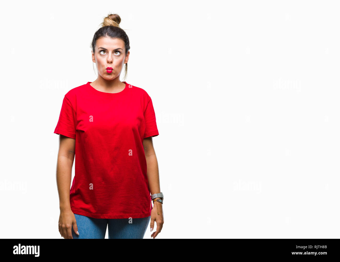Young beautiful woman over isolated background making fish face with ...