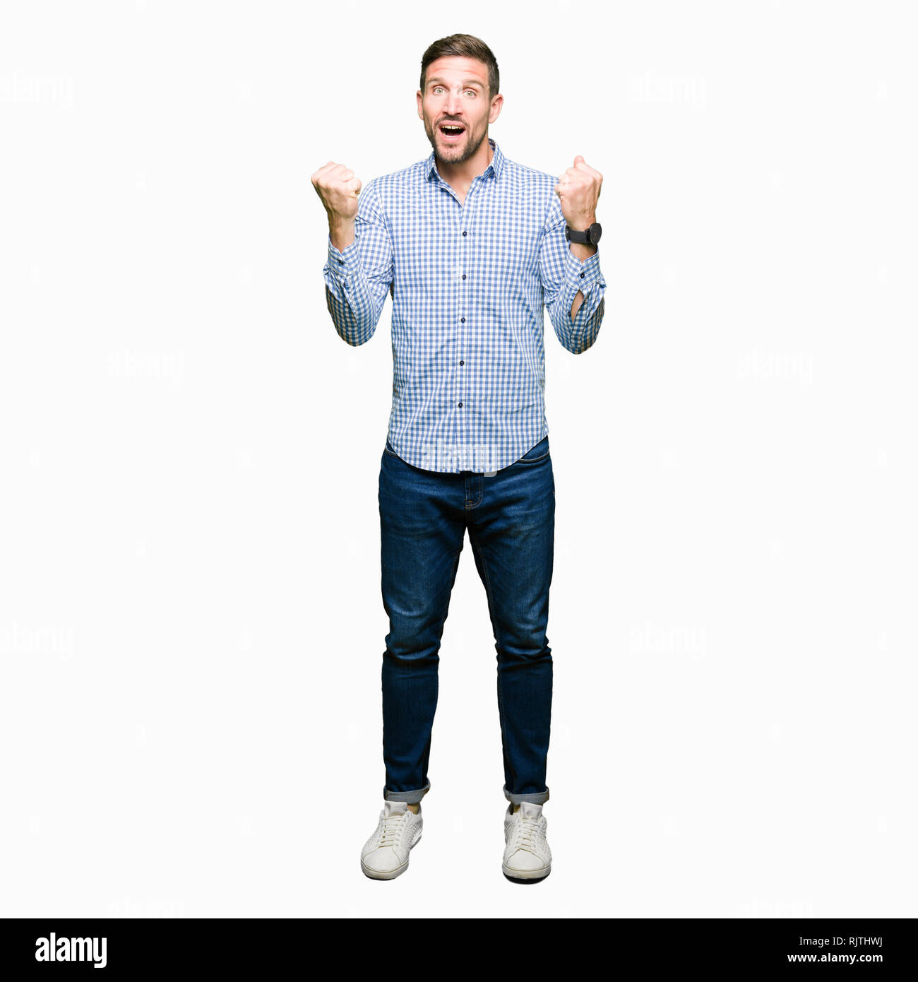 Handsome business man with blue eyes celebrating surprised and amazed ...