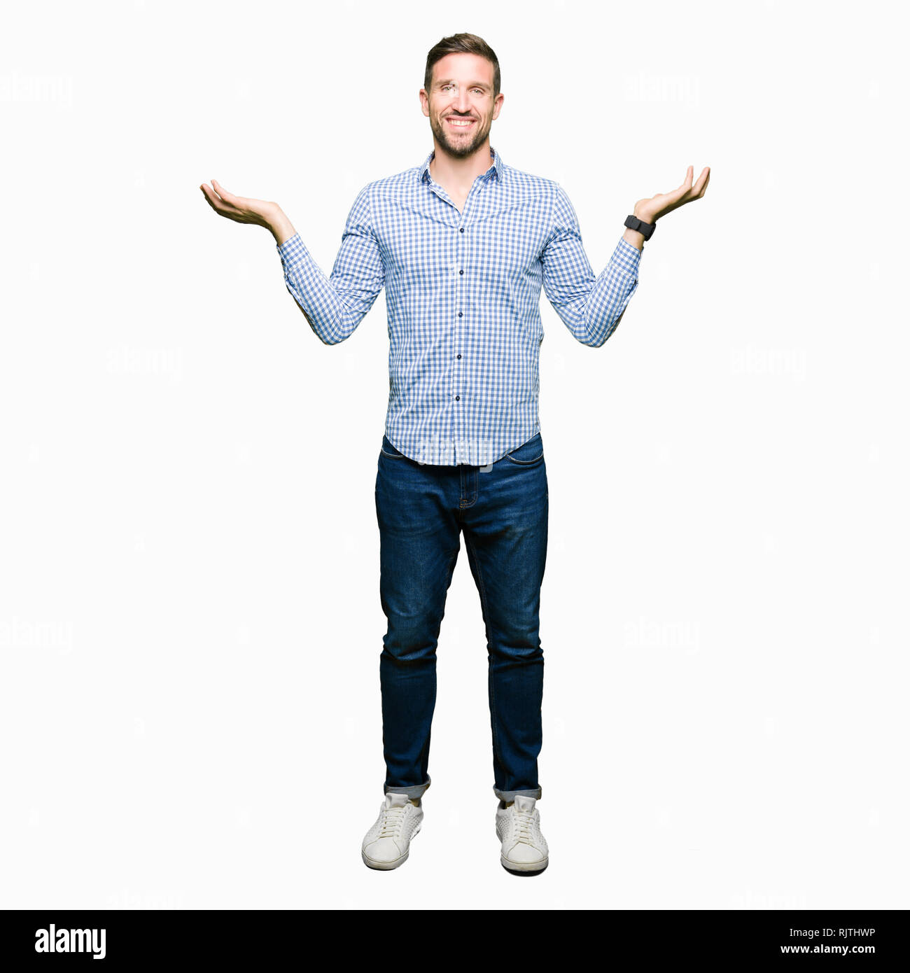 Handsome business man with blue eyes Smiling showing both hands open ...