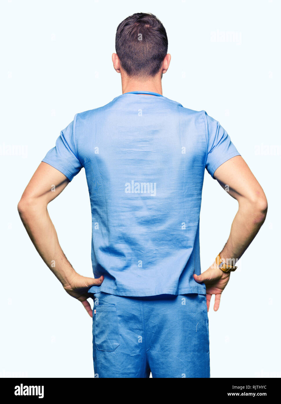 Handsome doctor man wearing medical uniform over isolated background ...