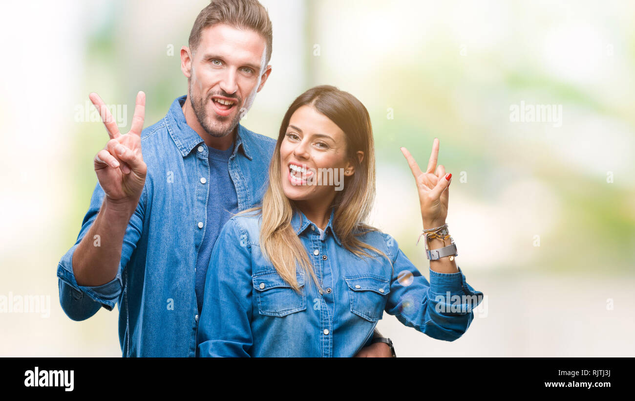 Young couple in love over isolated background smiling with happy face ...