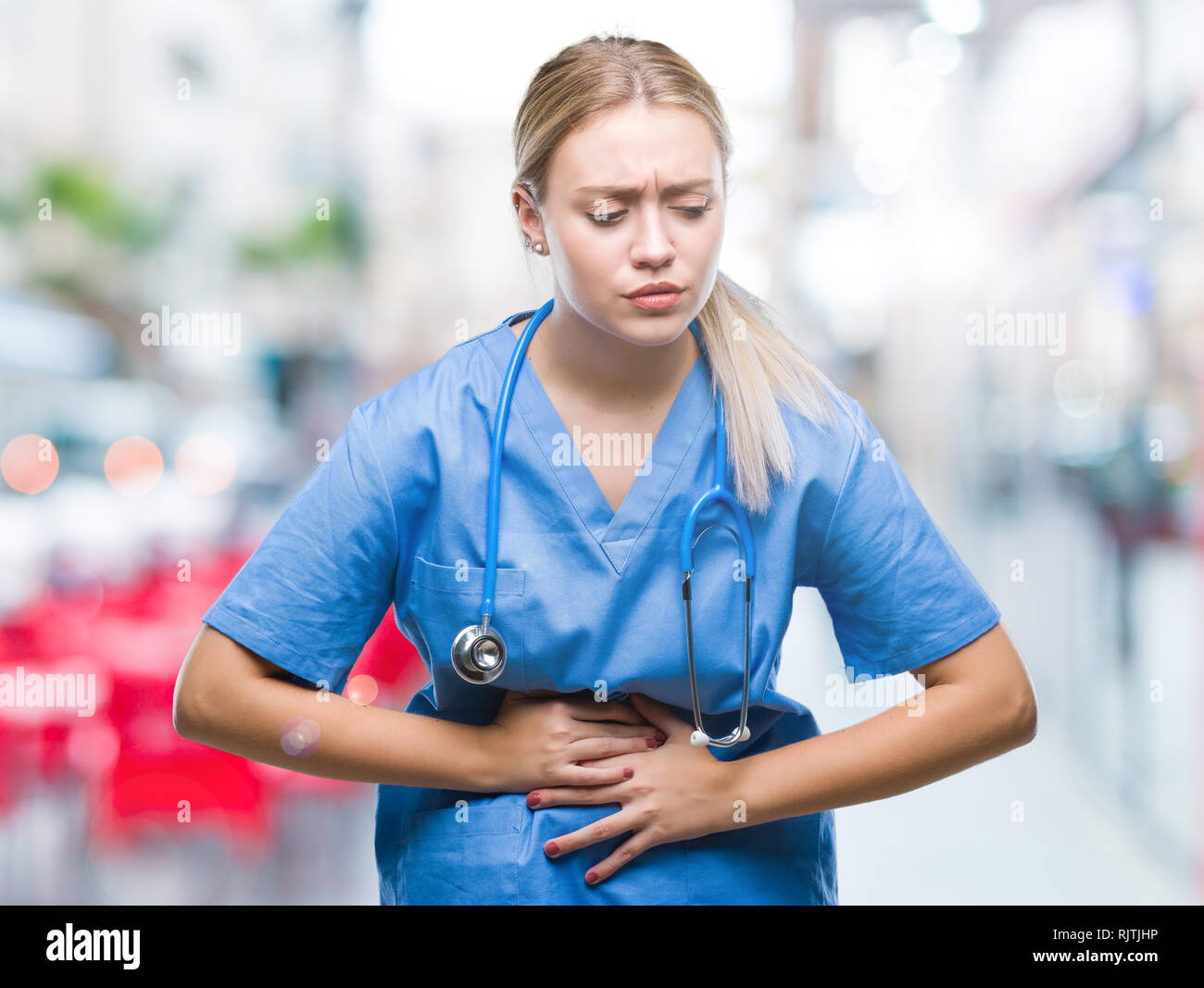 Young blonde surgeon doctor woman over isolated background with hand on ...