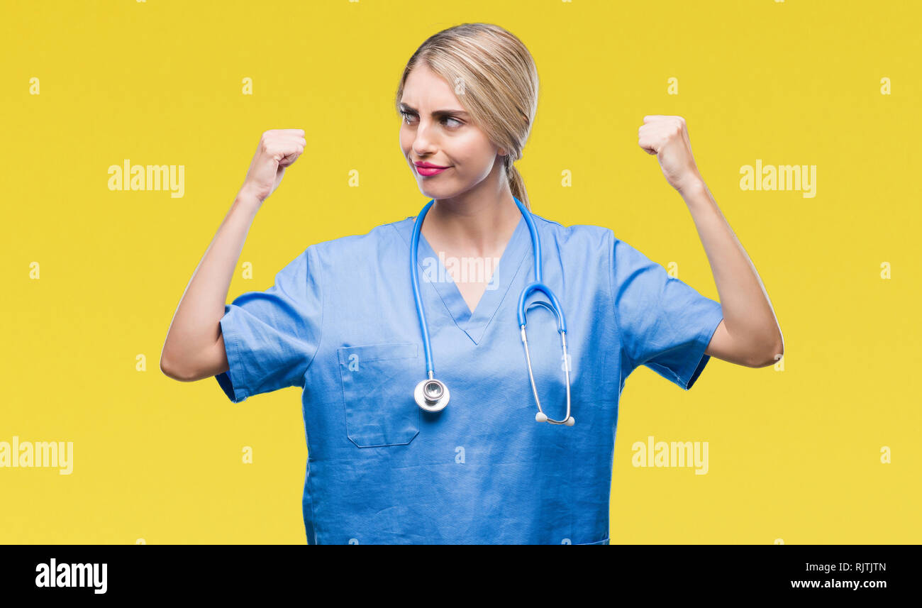 Young beautiful blonde doctor surgeon nurse woman over isolated ...