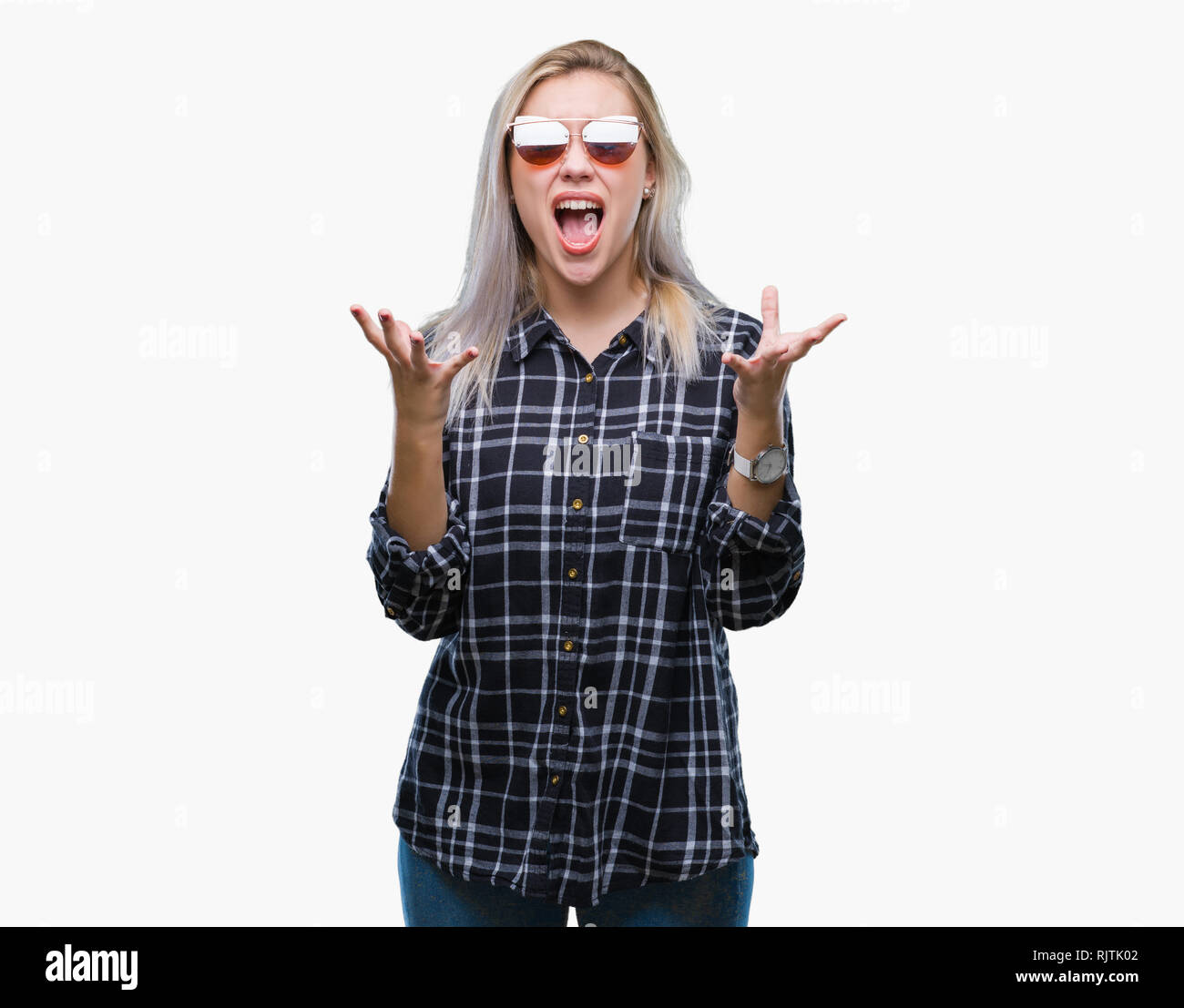 Young blonde woman wearing sunglasses over isolated background crazy ...