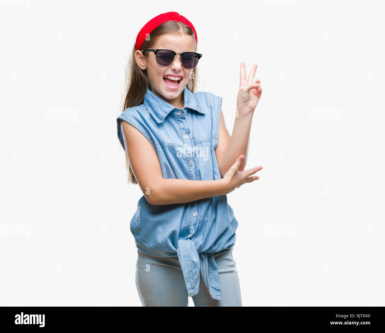 Young beautiful girl wearing sunglasses over isolated background ...