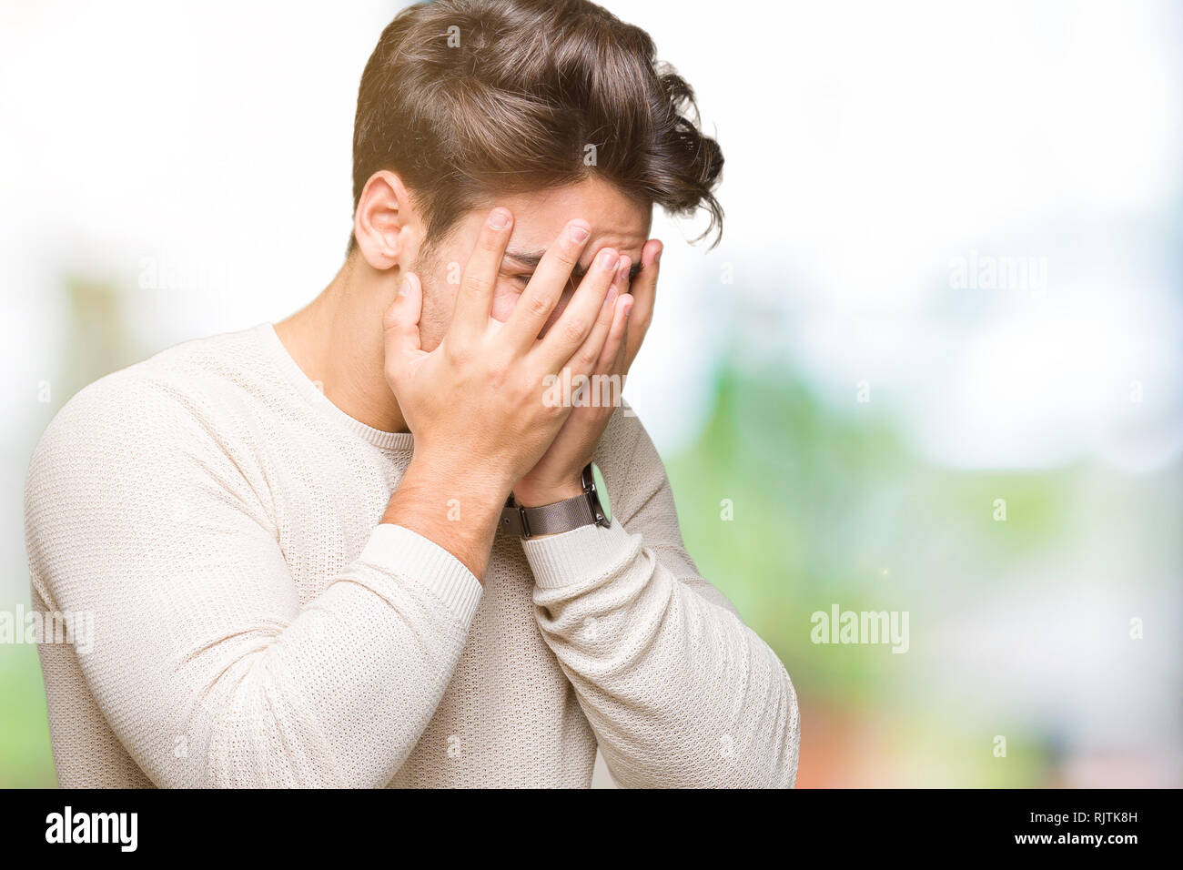 Young handsome man over isolated background with sad expression ...