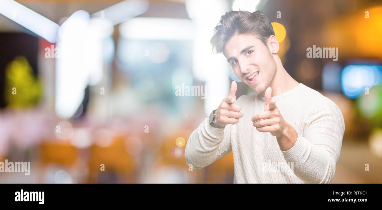 Young handsome man over isolated background pointing fingers to camera ...