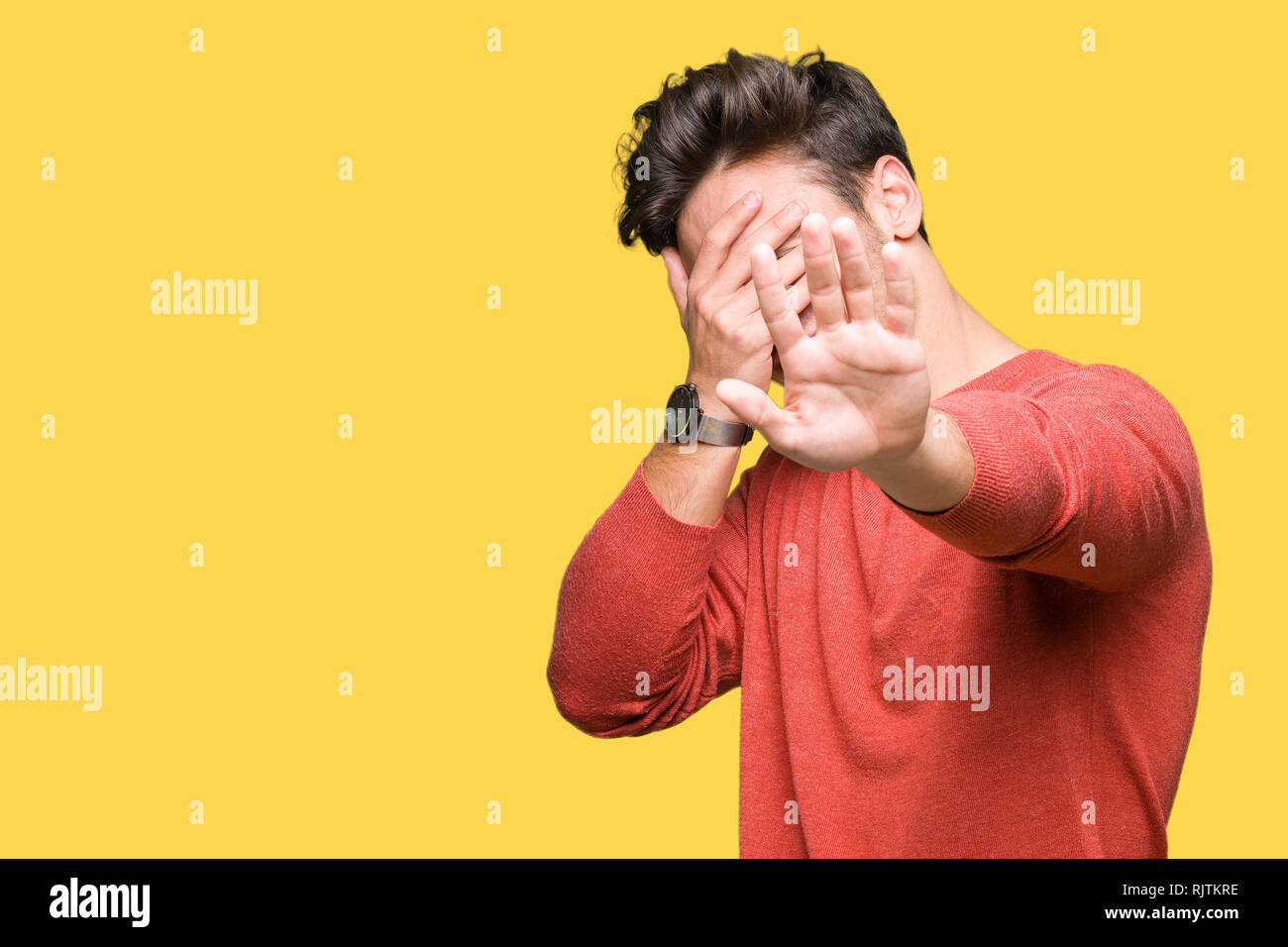 Young handsome man over isolated background covering eyes with hands ...