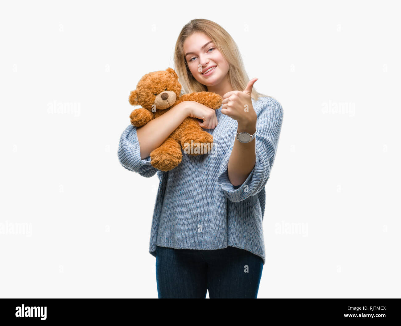 Young caucasian woman holding cute teddy bear over isolated background ...