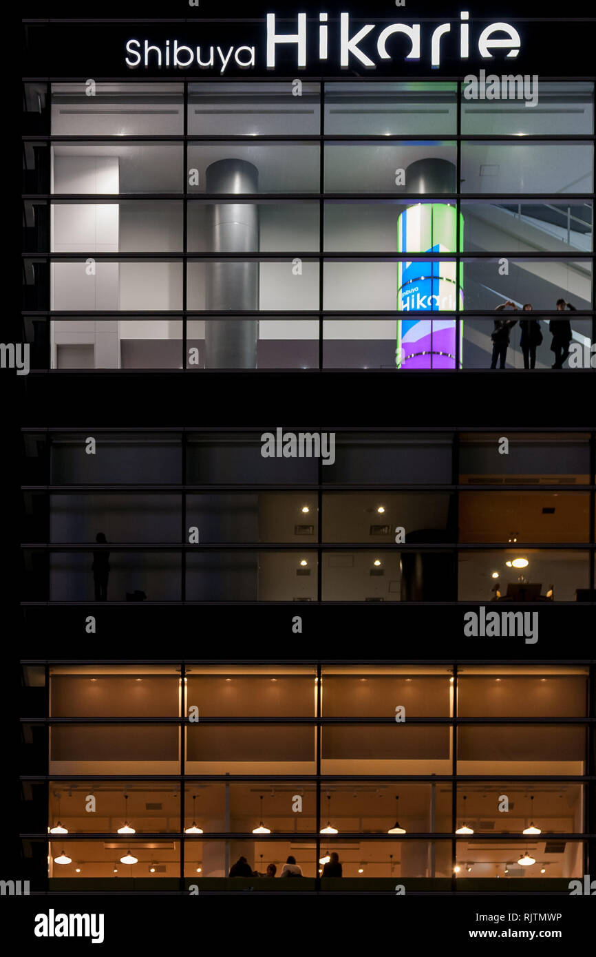 People look at the windows of the Hikarie Tower in Shibuya, Tokyo ...