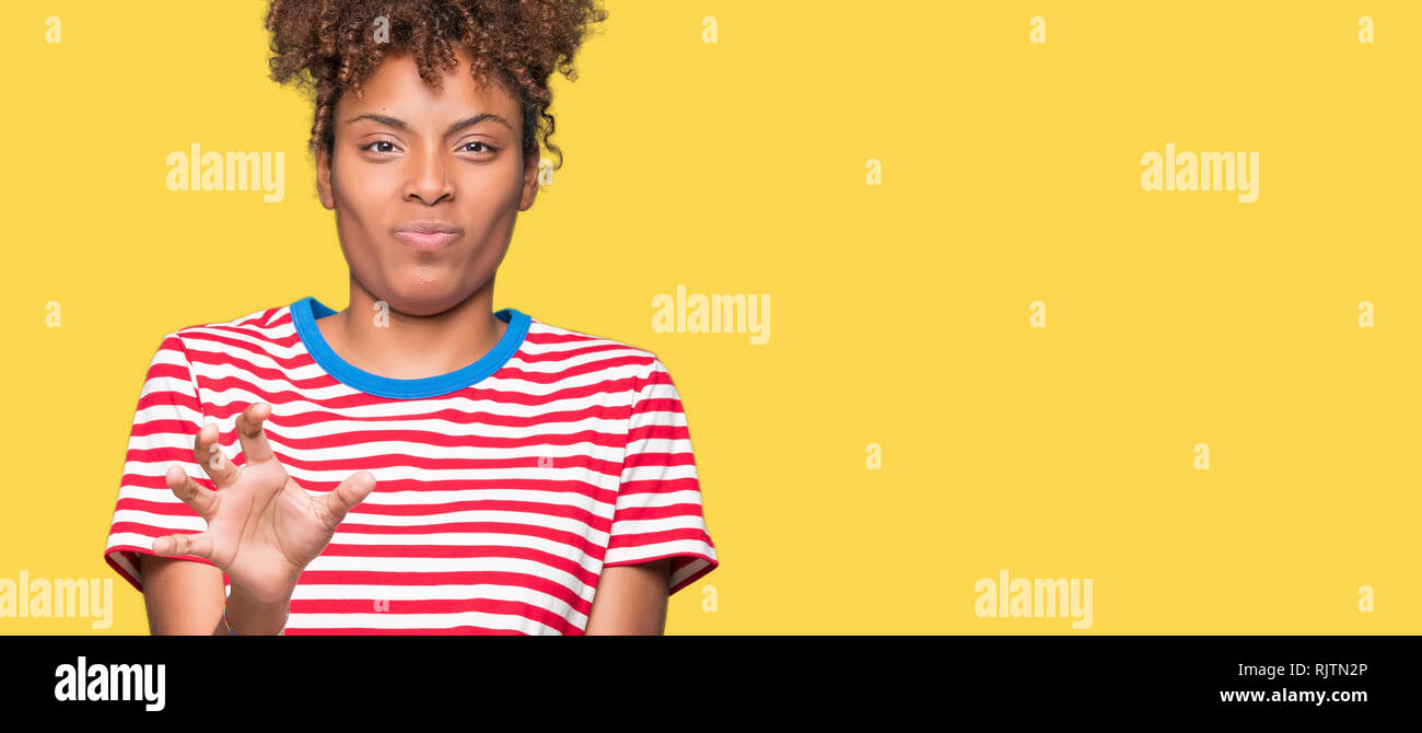 Beautiful young african american woman over isolated background ...