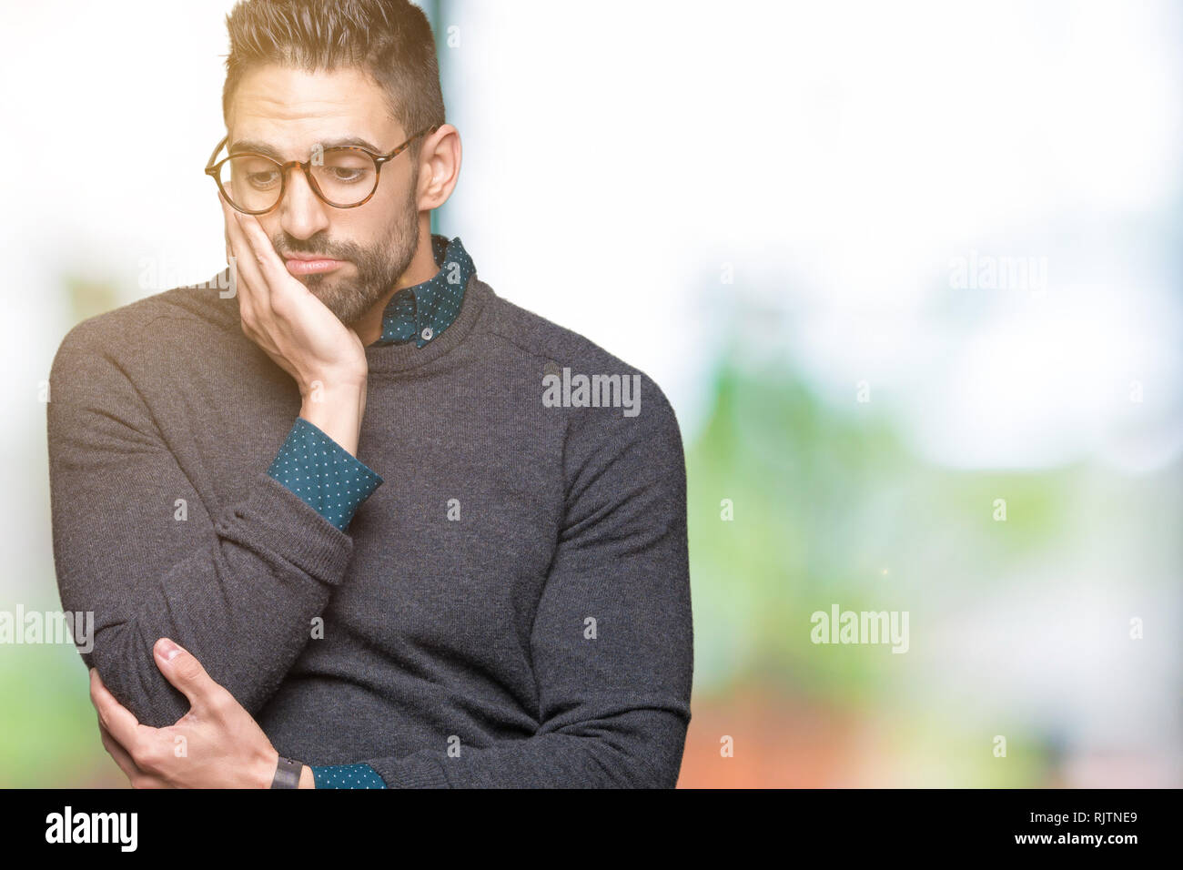 Young handsome man wearing glasses over isolated background thinking ...