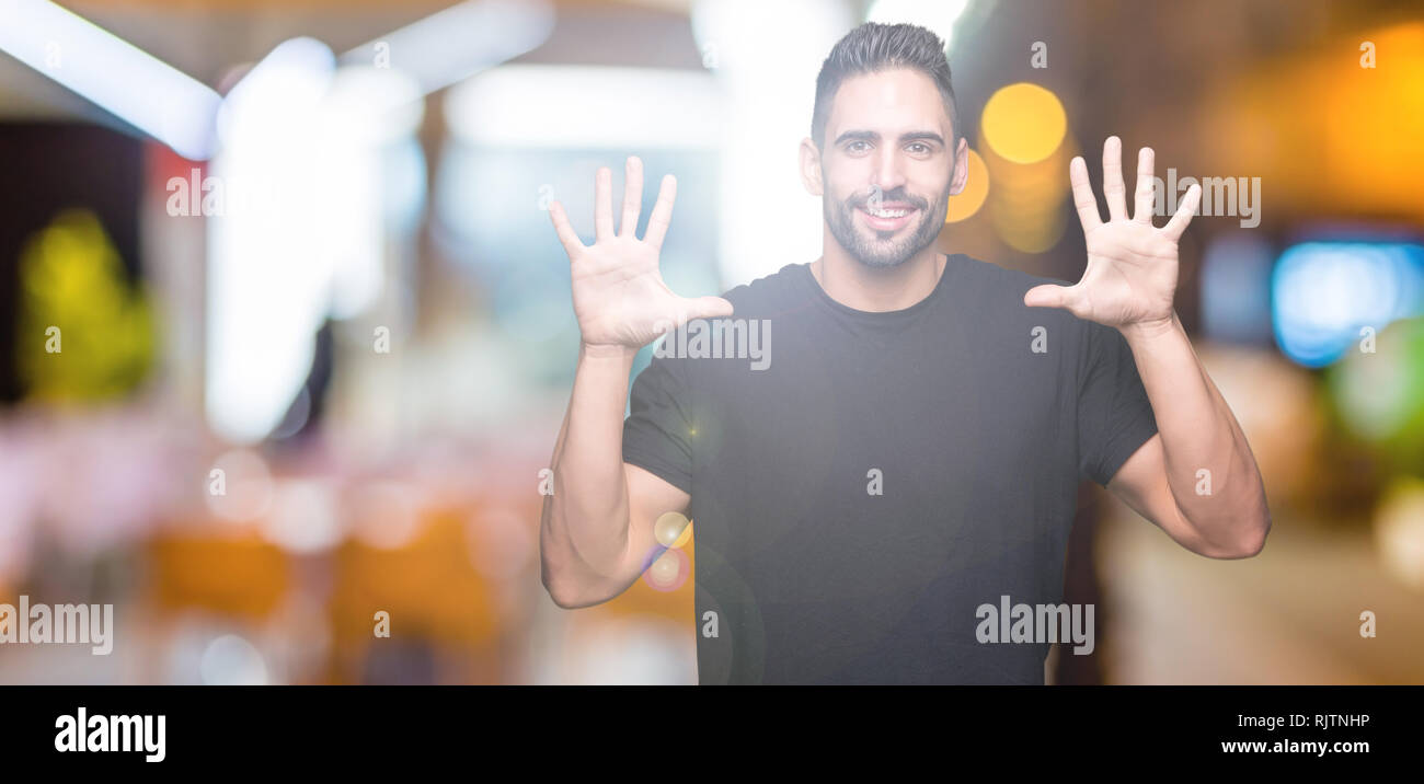 Young handsome man over isolated background showing and pointing up ...