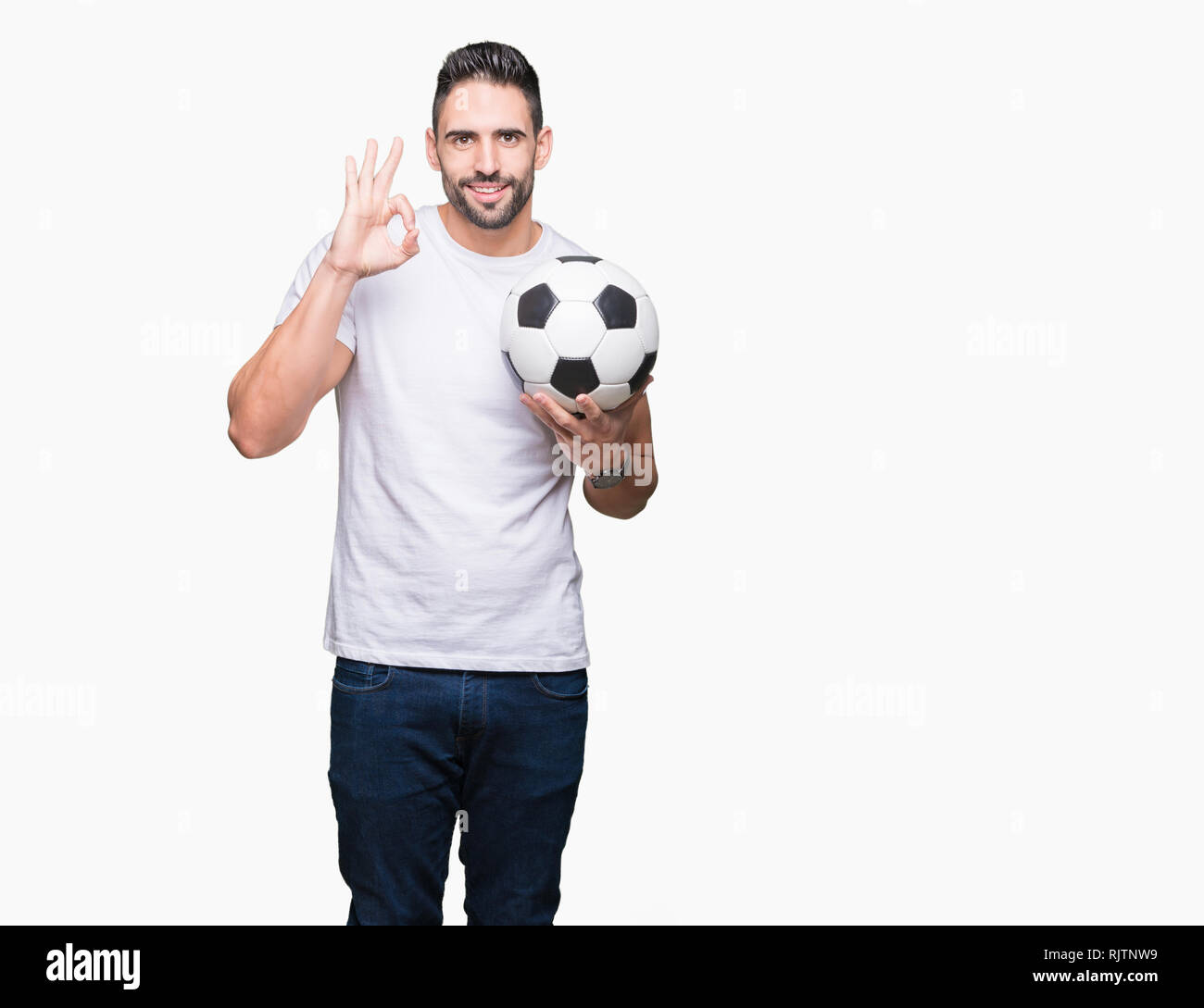 Young man holding soccer football ball over isolated background doing ...
