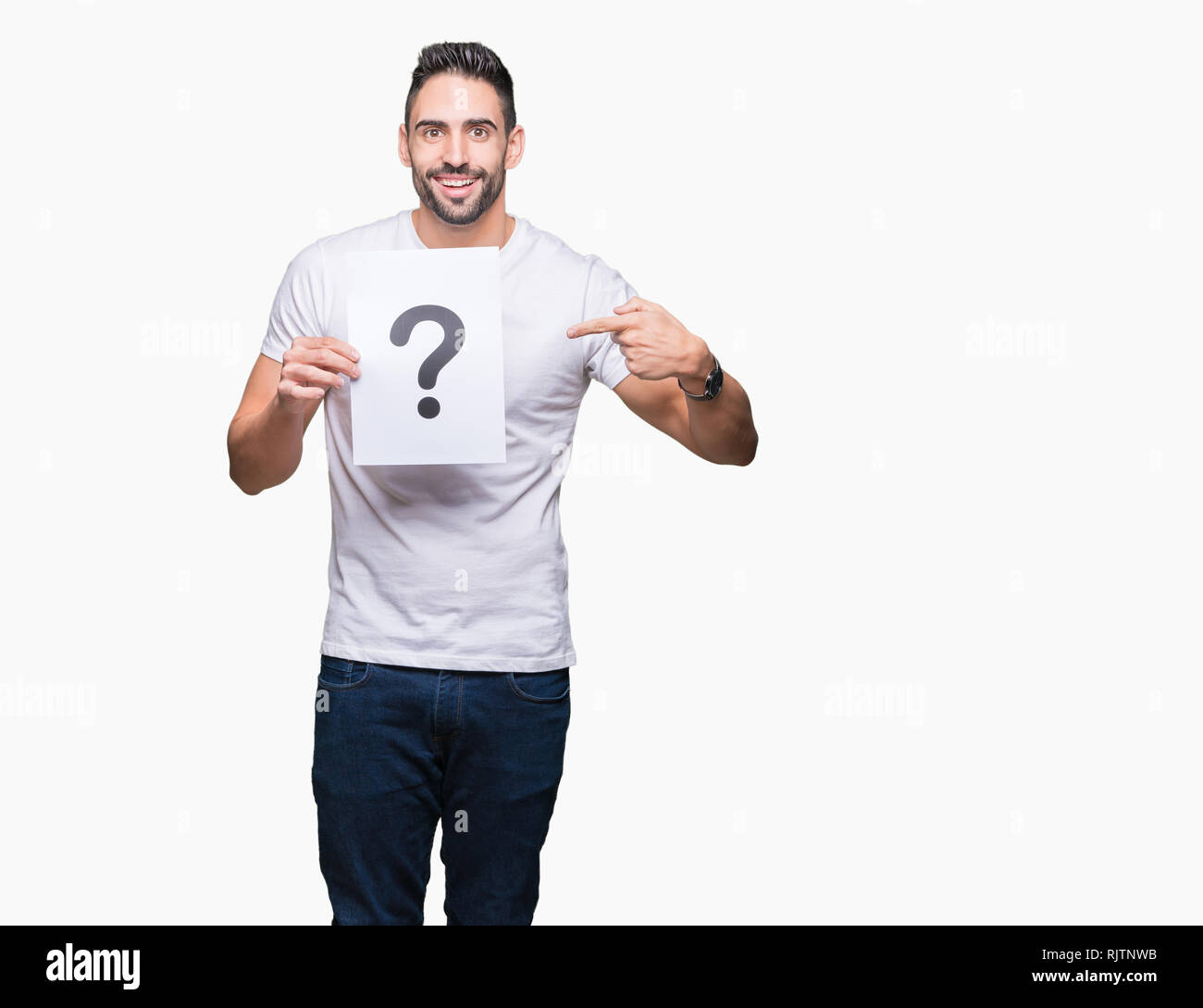 Handsome young man holding paper with question mark over isolated ...