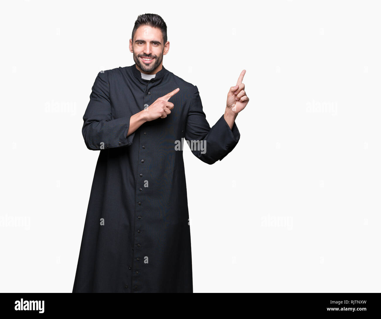Young Christian priest over isolated background smiling and looking at ...