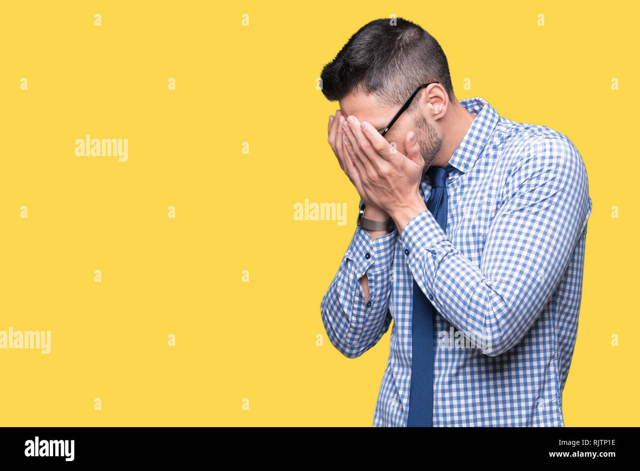 Young business man wearing glasses over isolated background with sad ...