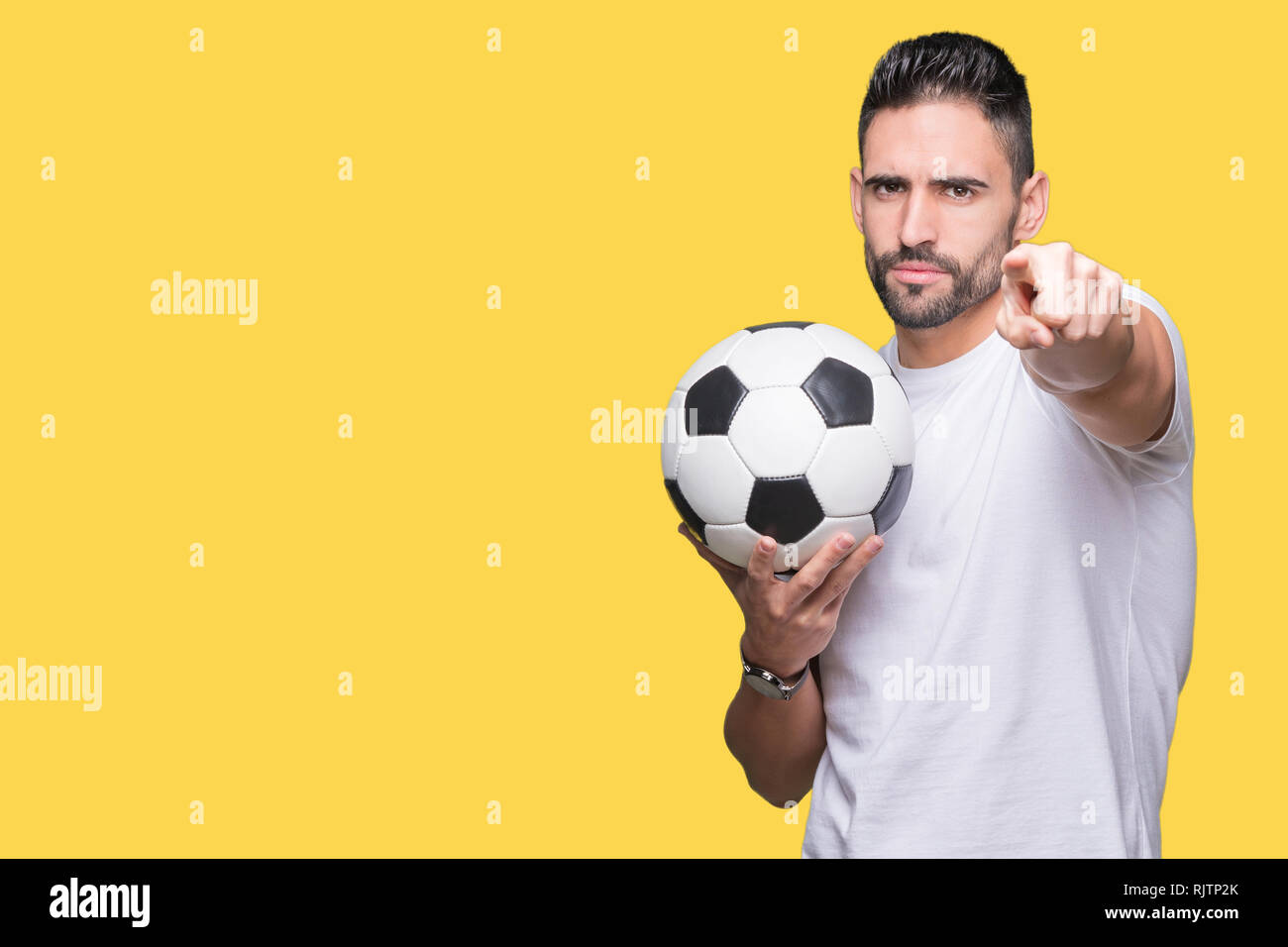 Young man holding soccer football ball over isolated background ...