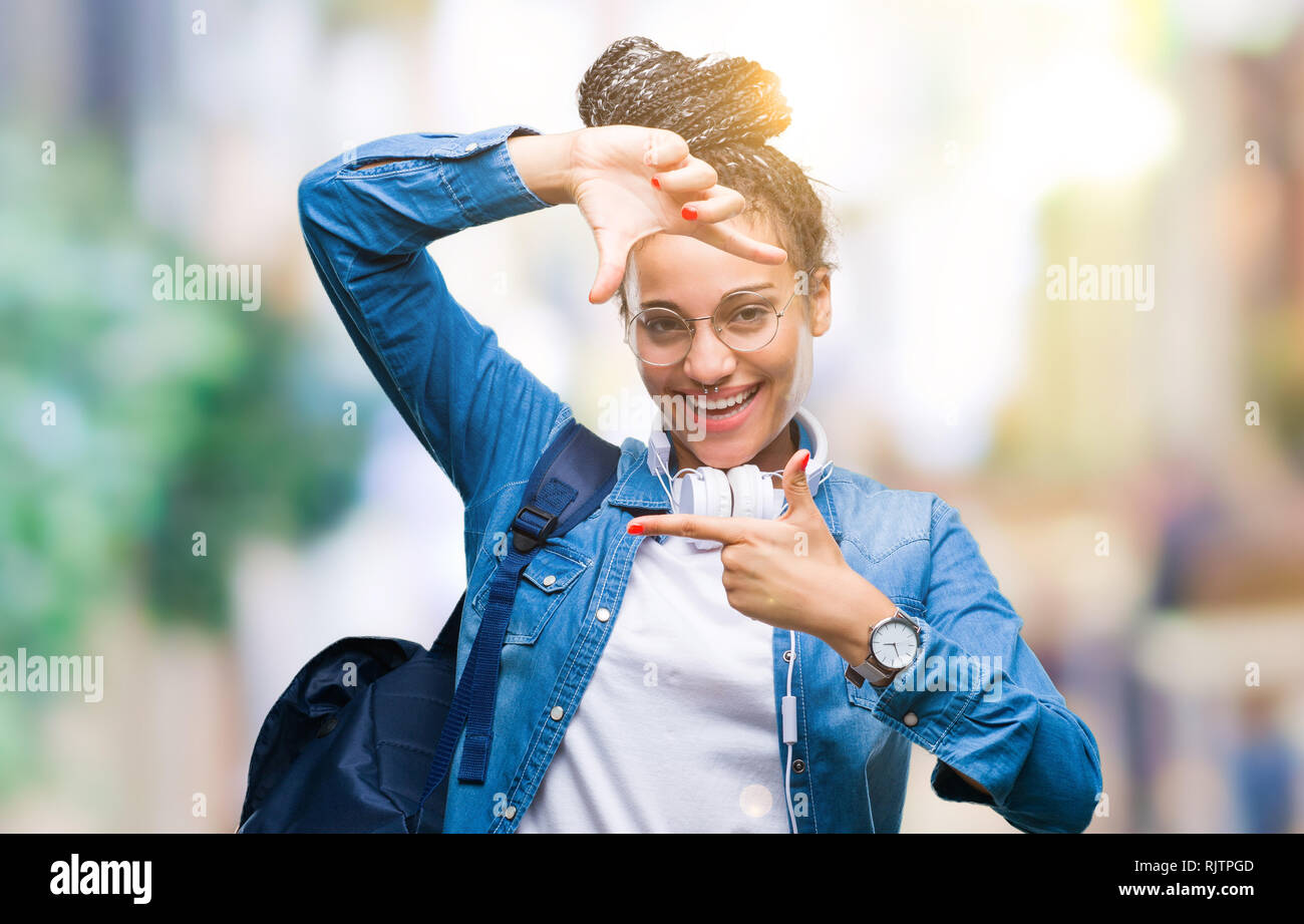 Young braided hair african american student girl wearing backpack over ...