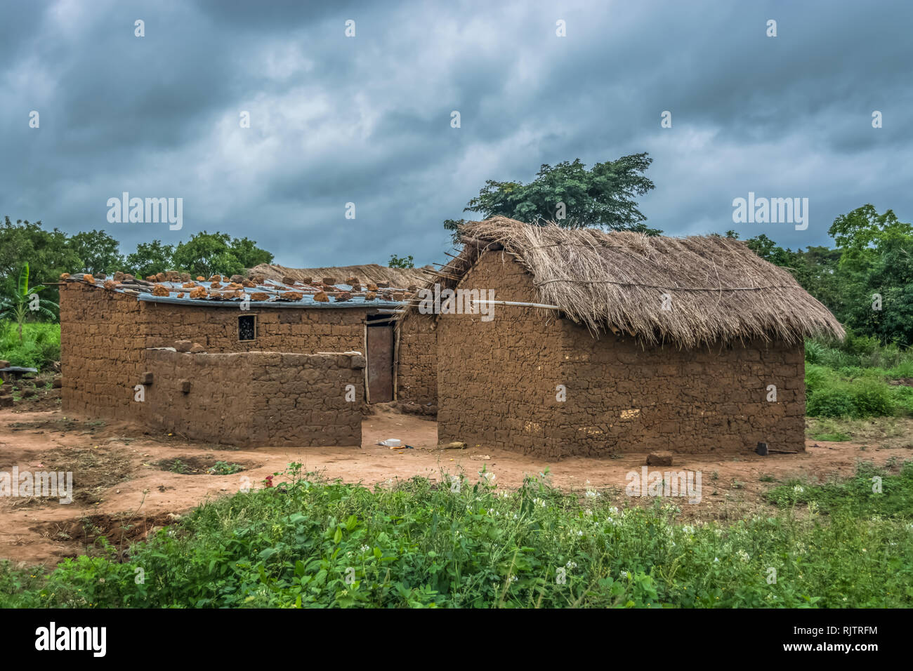 View of traditional village, house thatched on roof and terracotta ...