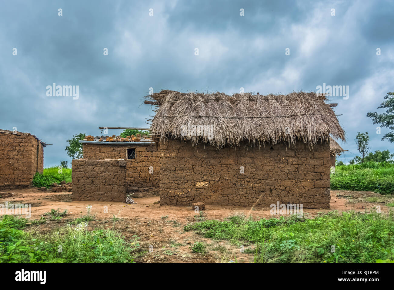 View of traditional village, house thatched on roof and terracotta ...