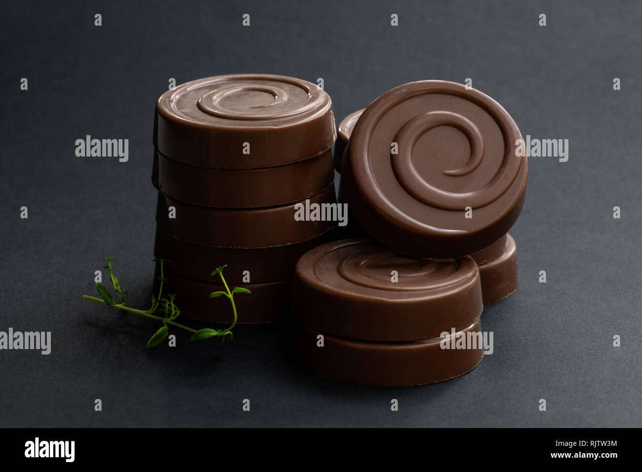 Stacked chocolate swirl biscuits on black background Stock Photo - Alamy