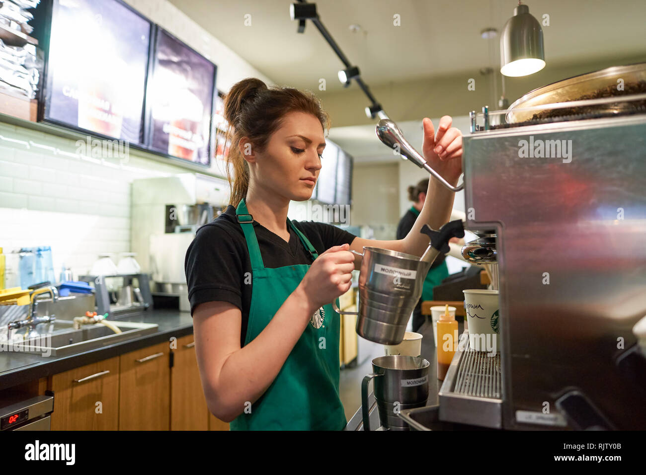 SAINT PETERSBURG, RUSSIA - MARCH 12, 2016: worker at Starbucks Cafe ...