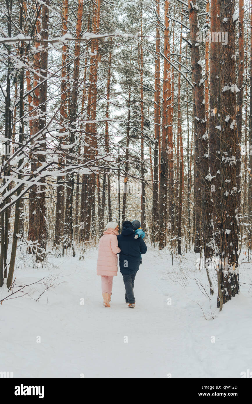 Walking family with a child. Family walks in nature in winter. Winter ...