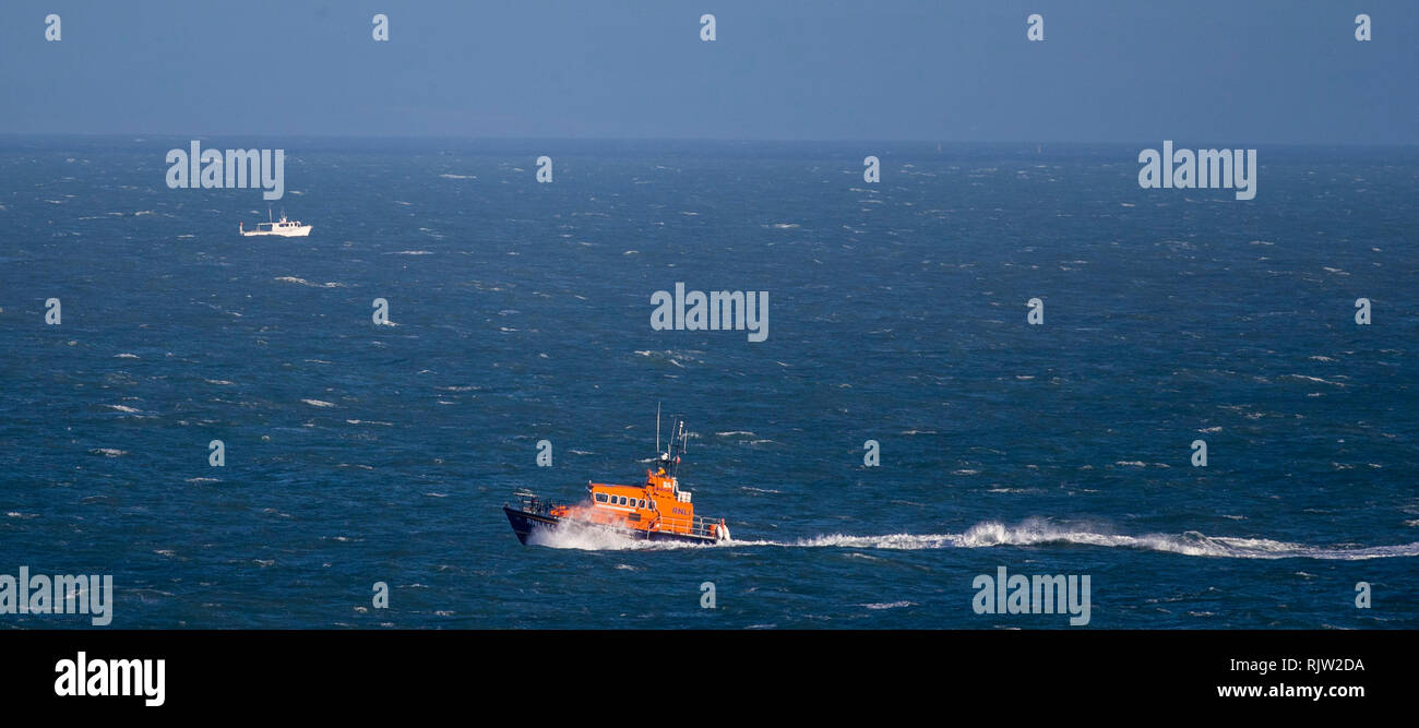 A Trent class RNLI lifeboat sails near Old Harry Rocks in Studland ...