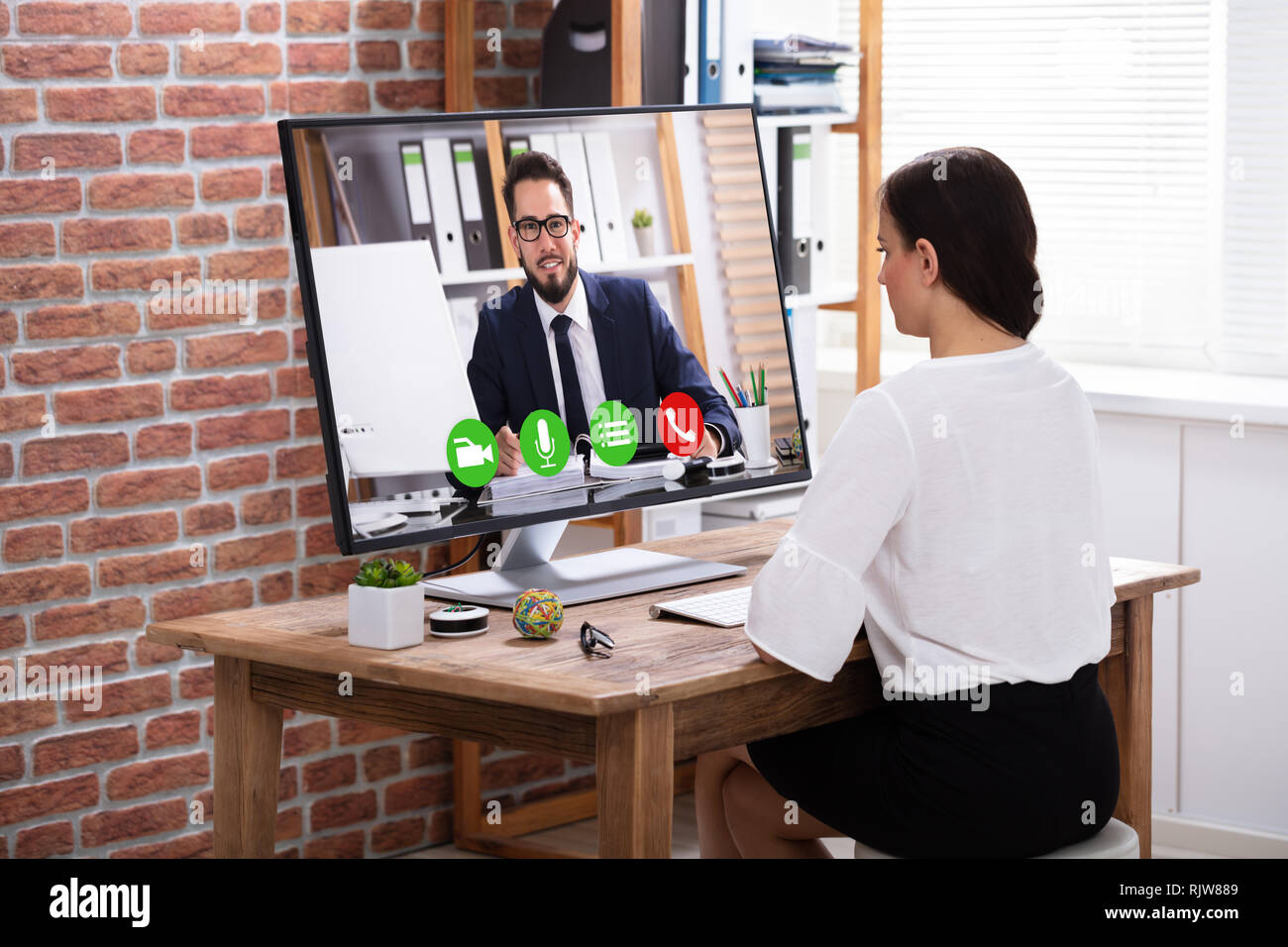 Rear View Of Businesswoman Looking At Computer With White Blank Screen ...