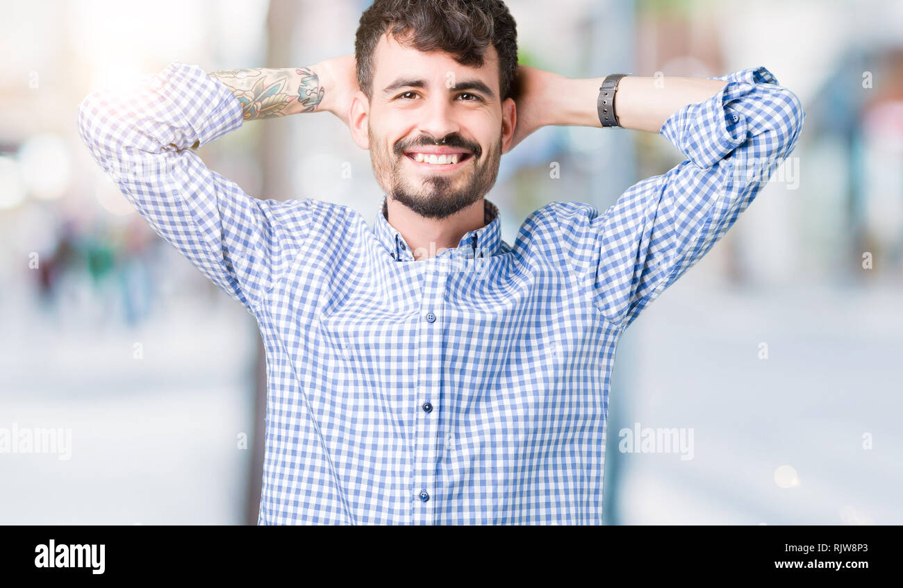 Young handsome business man over isolated background Relaxing and ...