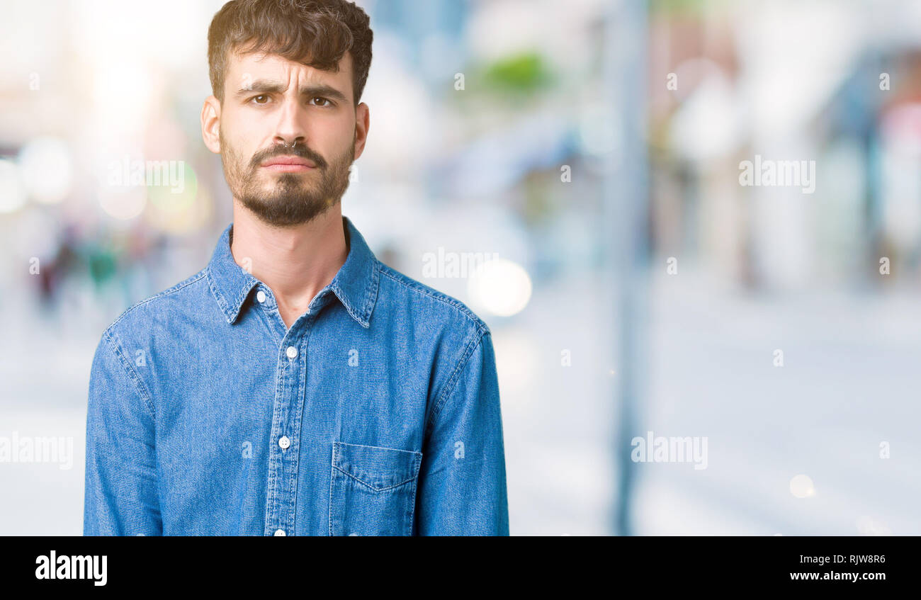 Young handsome man over isolated background depressed and worry for ...
