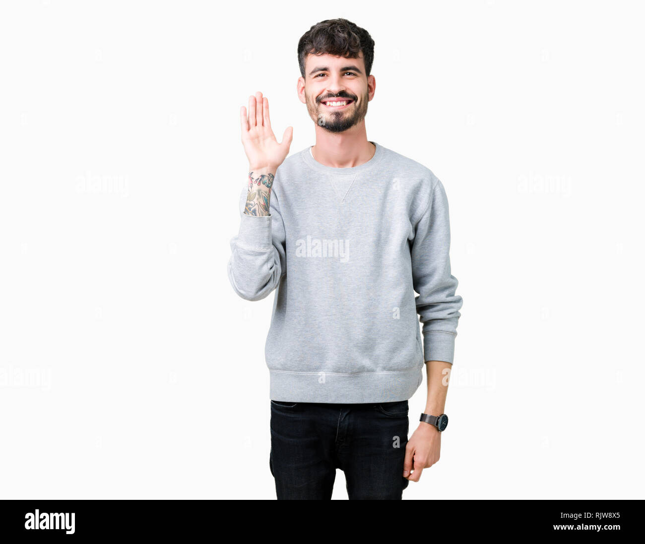 Young handsome man wearing sweatshirt over isolated background Waiving ...
