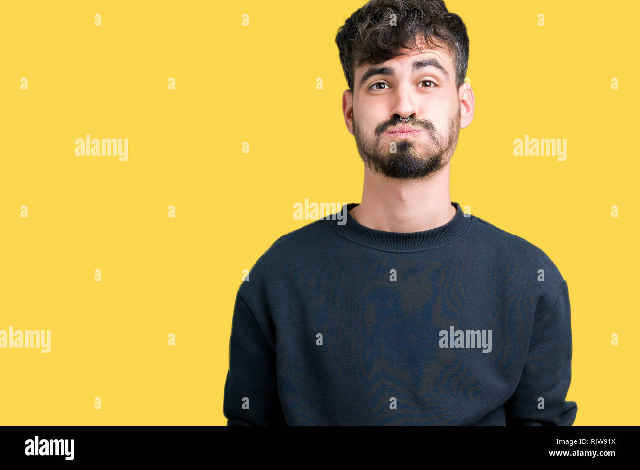 Young handsome man over isolated background puffing cheeks with funny ...