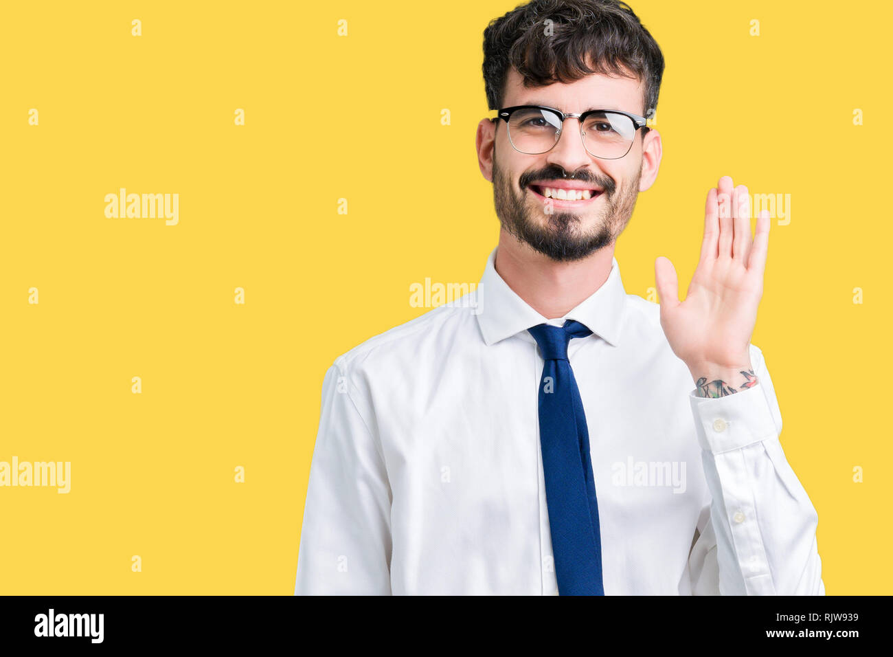 Young handsome business man wearing glasses over isolated background ...