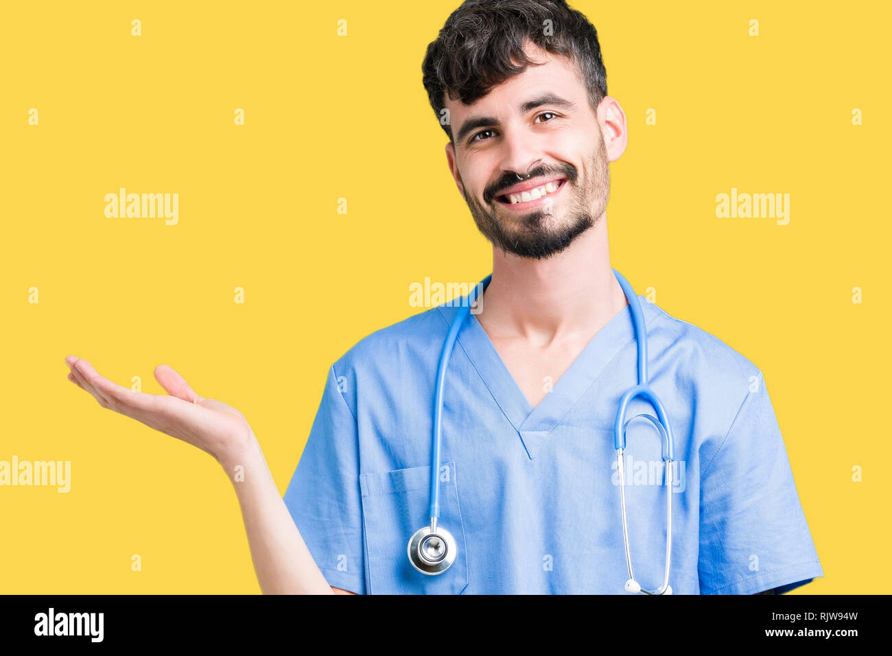 Young handsome nurse man wearing surgeon uniform over isolated ...