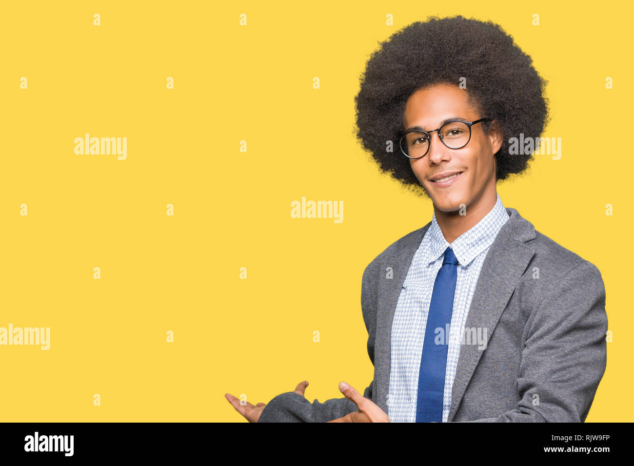 Young african american business man with afro hair wearing glasses ...