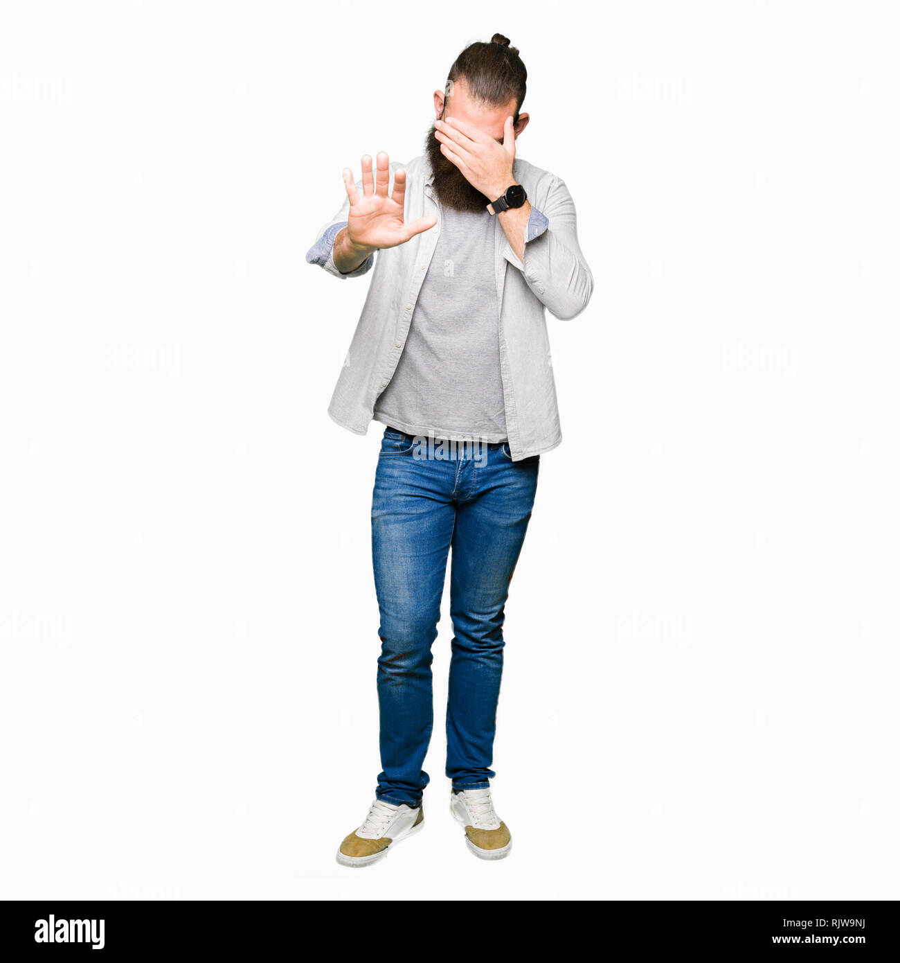 Young blond man wearing glasses covering eyes with hands and doing stop ...