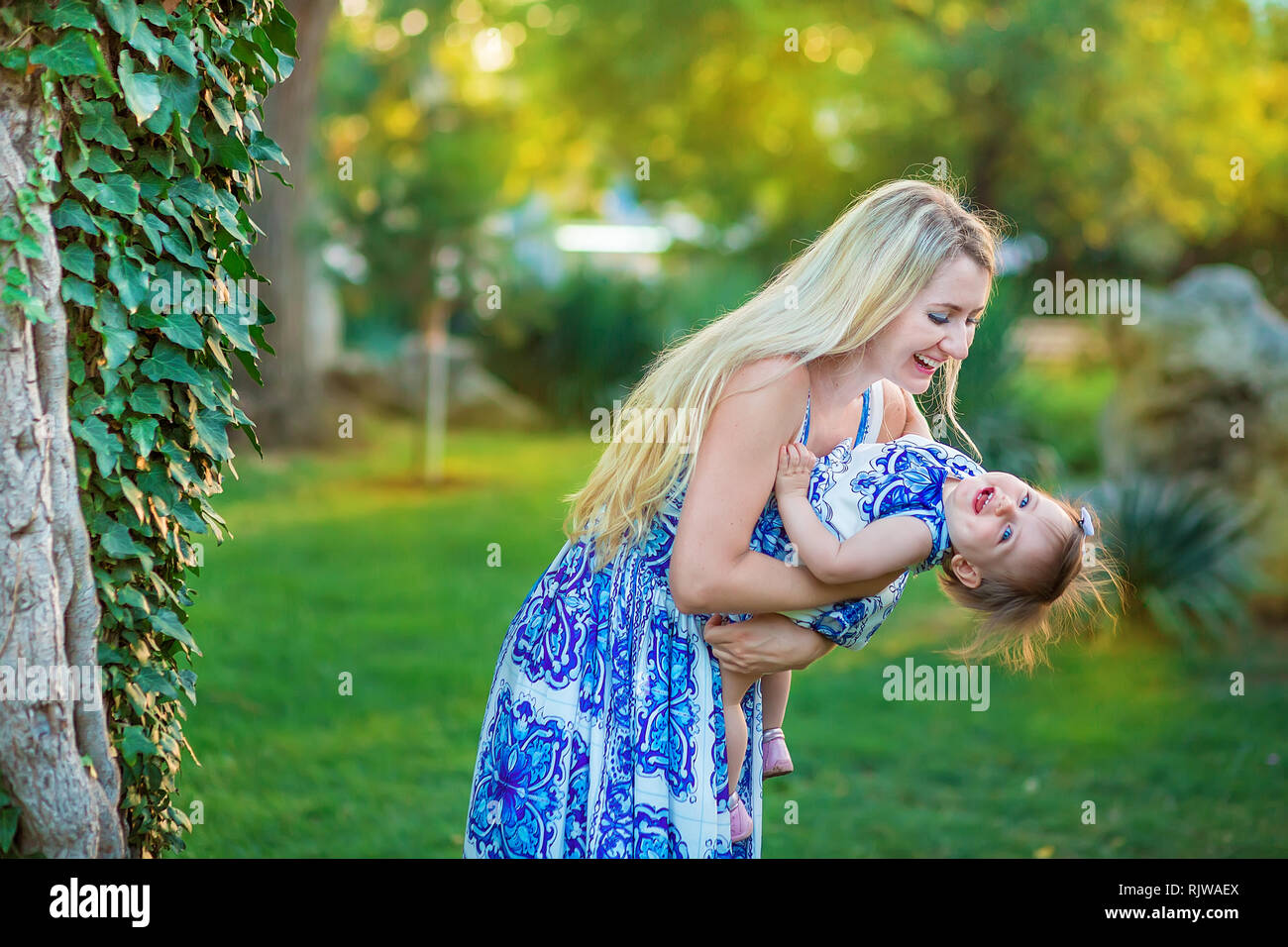 Mother and daughter playing in the park together happy woman freedom power feelings Stock Photo ...