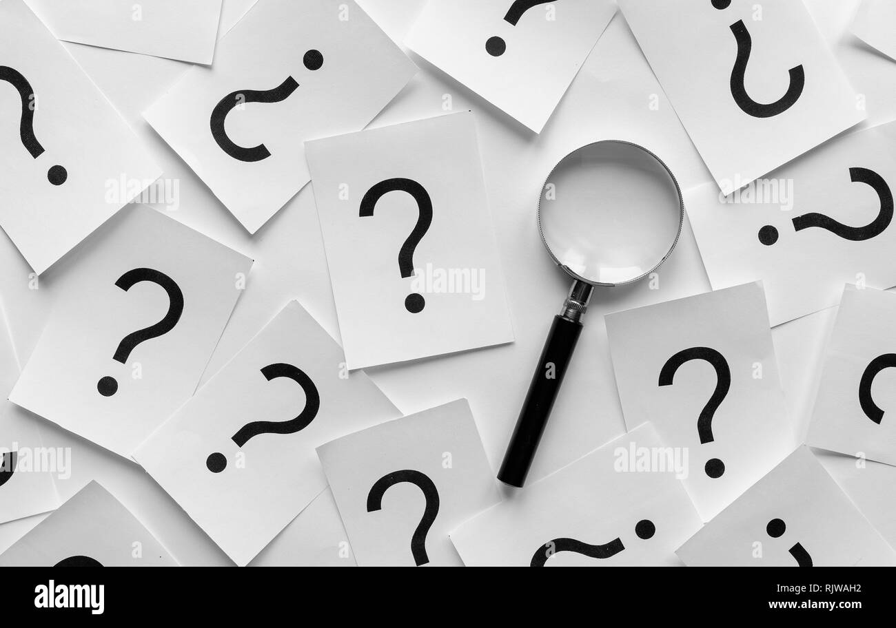 Background pattern of random question marks printed on white cards with ...